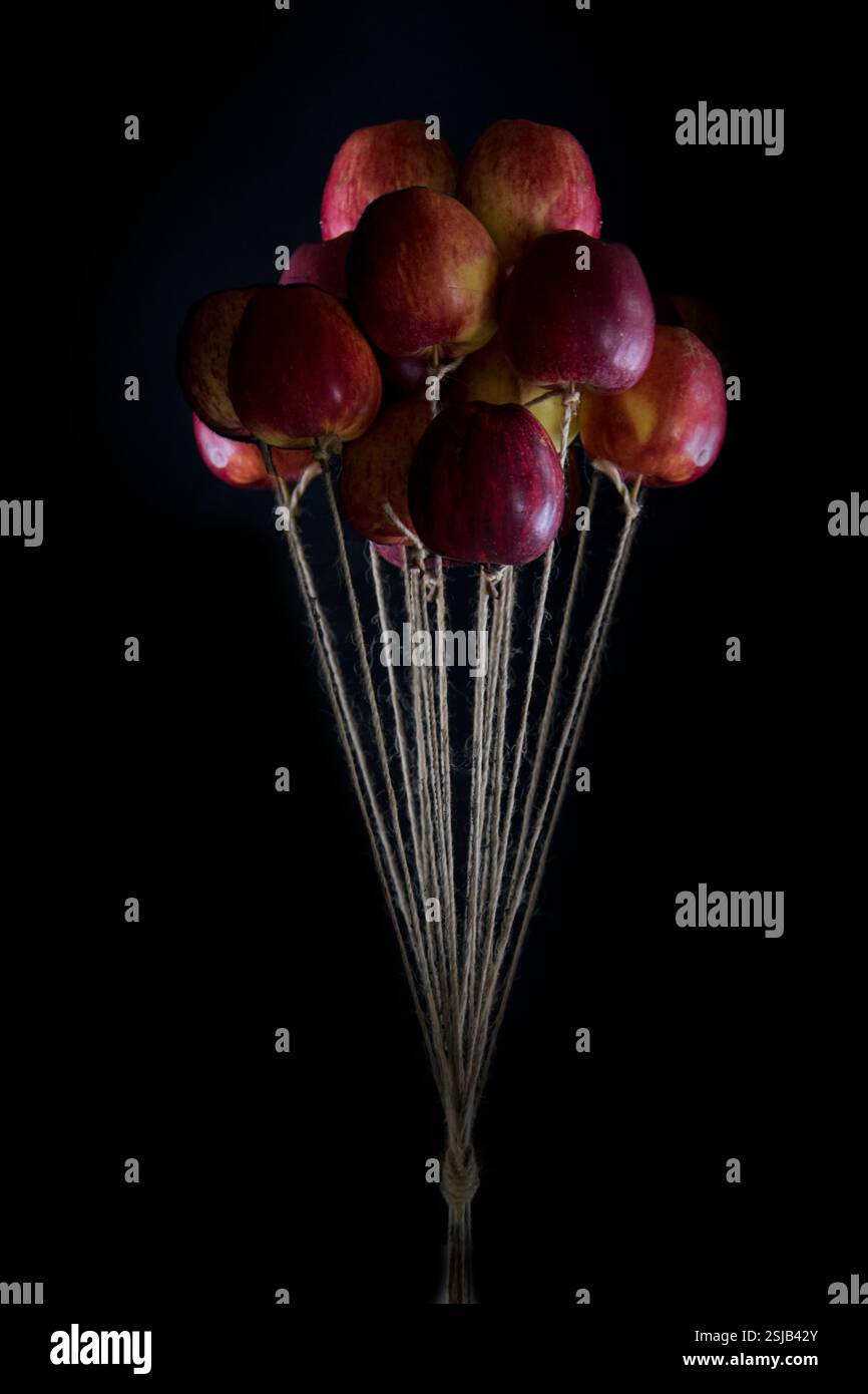 Surreal Apple Balloon Bouquet Against Dark Background Stock Photo - Alamy