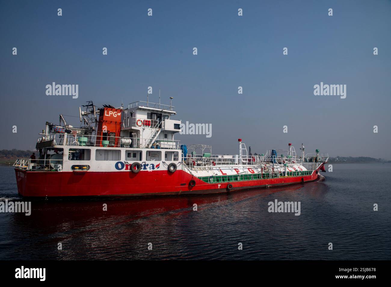 A fully loaded LPG vessel makes its way along the Shitalakshya River in ...