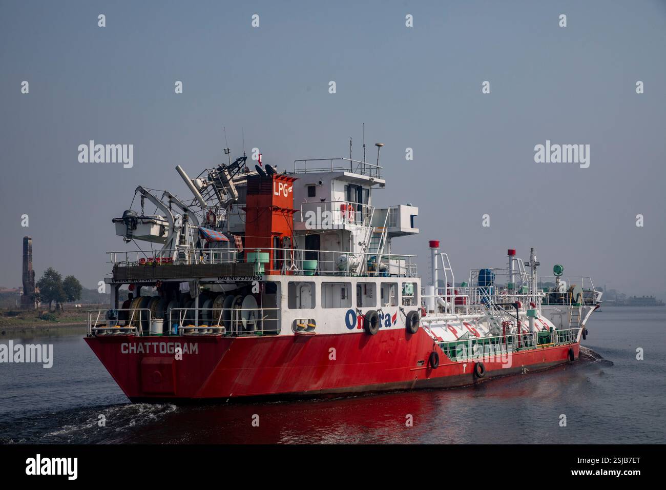 A fully loaded LPG vessel makes its way along the Shitalakshya River in ...