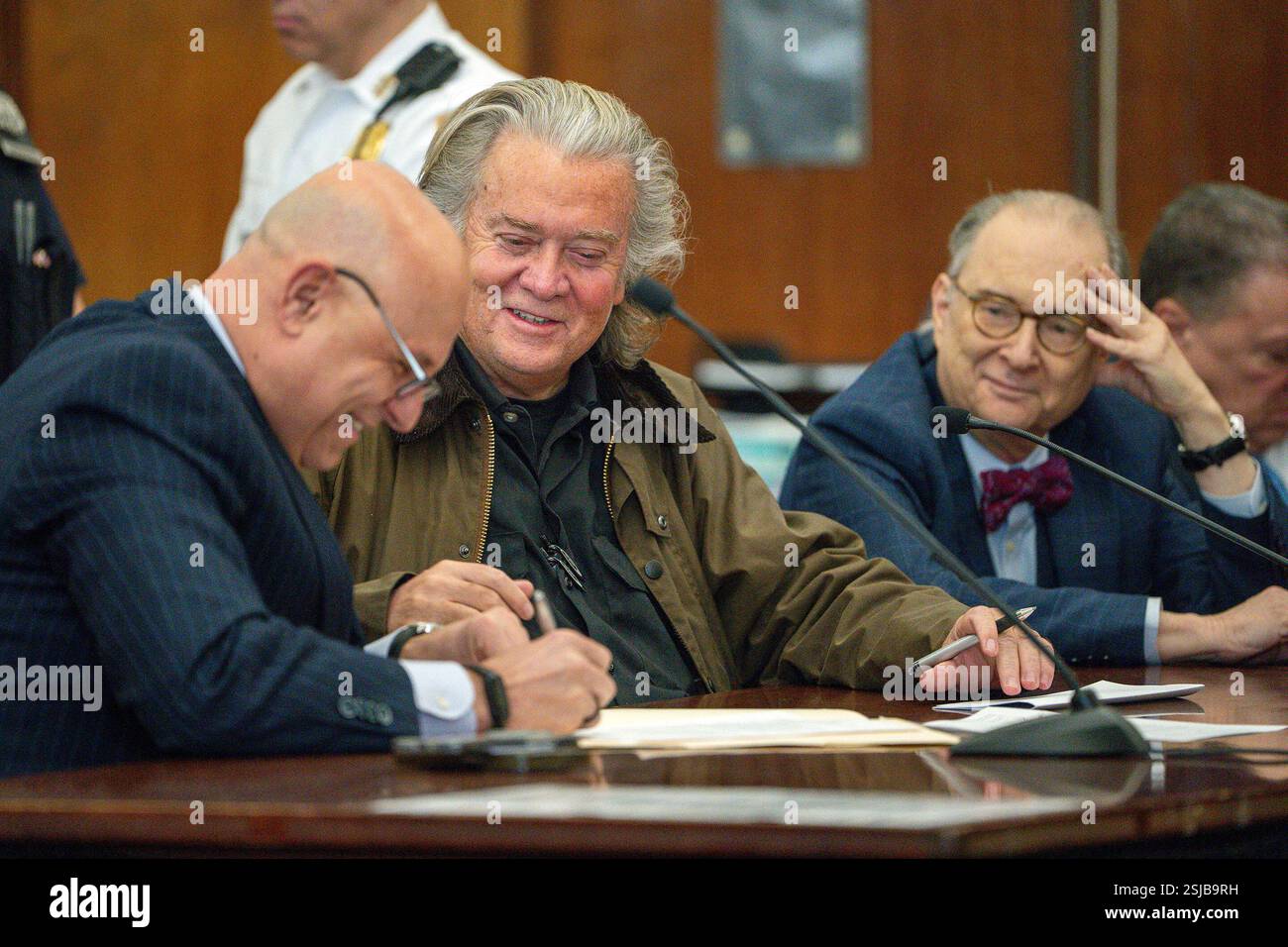 Steve Bannon speaks with his lawyers in court, Tuesday, Feb. 11, 2025 ...