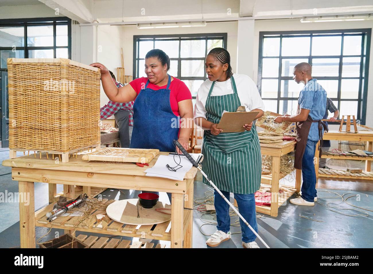 Group of artisans making woven furniture in workshop Stock Photo - Alamy