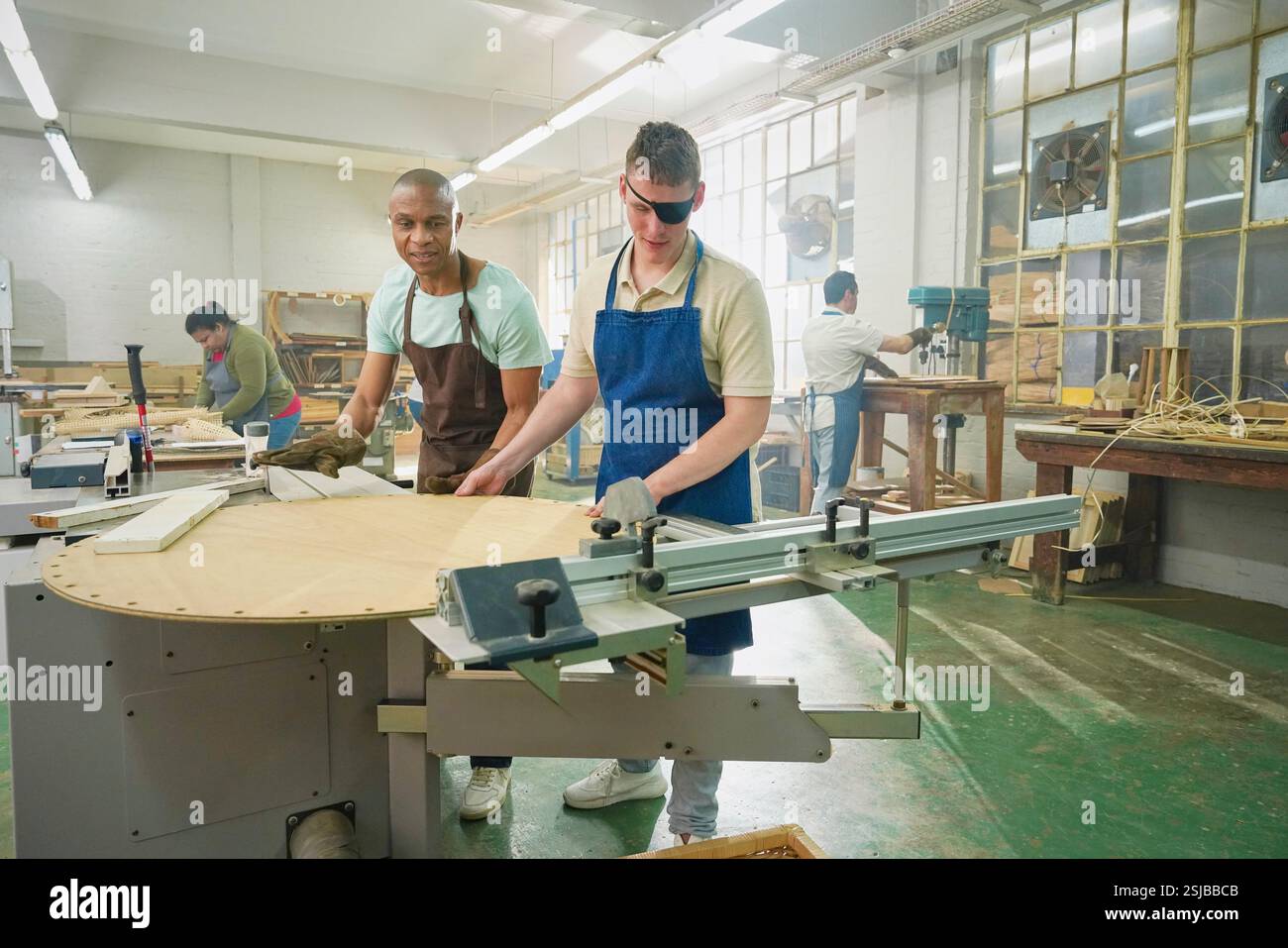 Group of craftsmen working in woodshop Stock Photo - Alamy