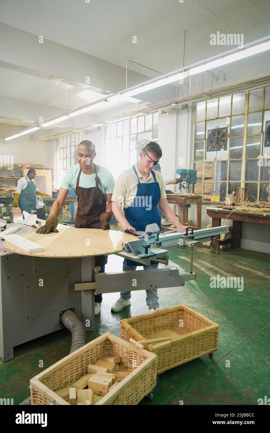 Group of craftsmen working in woodshop Stock Photo - Alamy