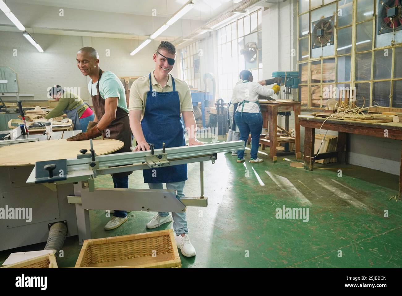 Group of craftsmen working in woodshop Stock Photo - Alamy