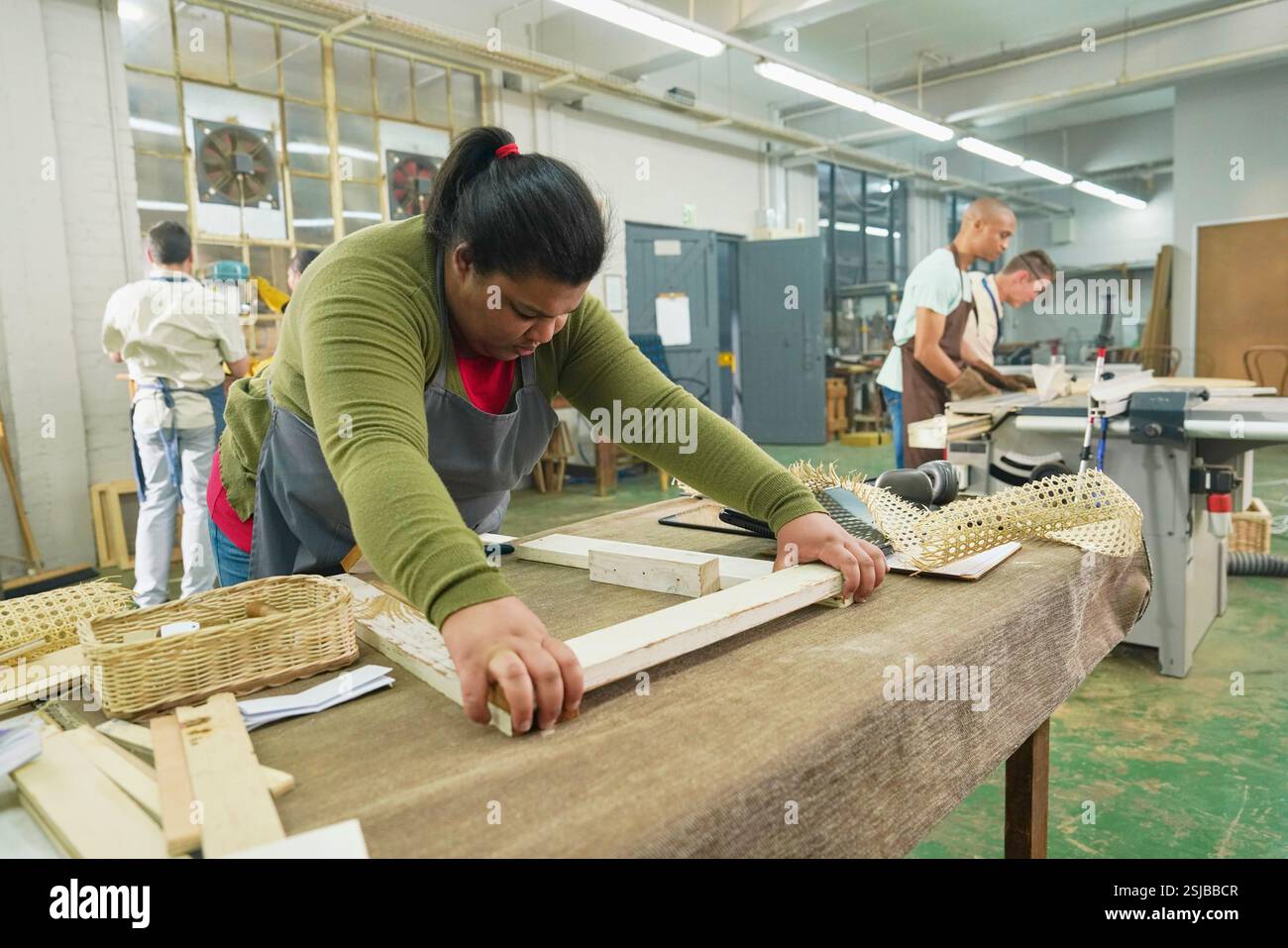 Group of craftsmen working in woodshop Stock Photo - Alamy