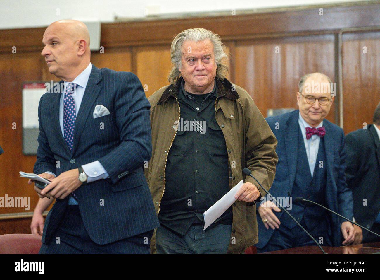 Steve Bannon walks with his lawyers in court, Tuesday, Feb. 11, 2025 in ...