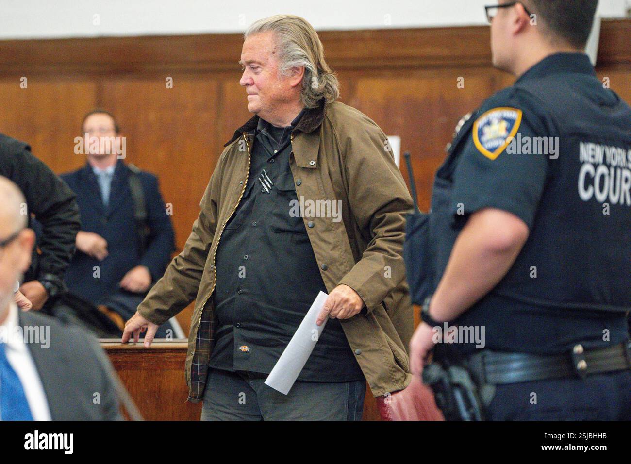Steve Bannon walks with his lawyers in court, Tuesday, Feb. 11, 2025 in ...