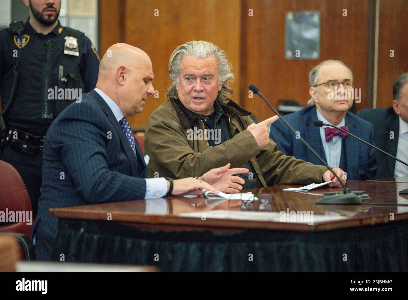 Steve Bannon speaks with one of his laywyers in court, Tuesday, Feb. 11 ...