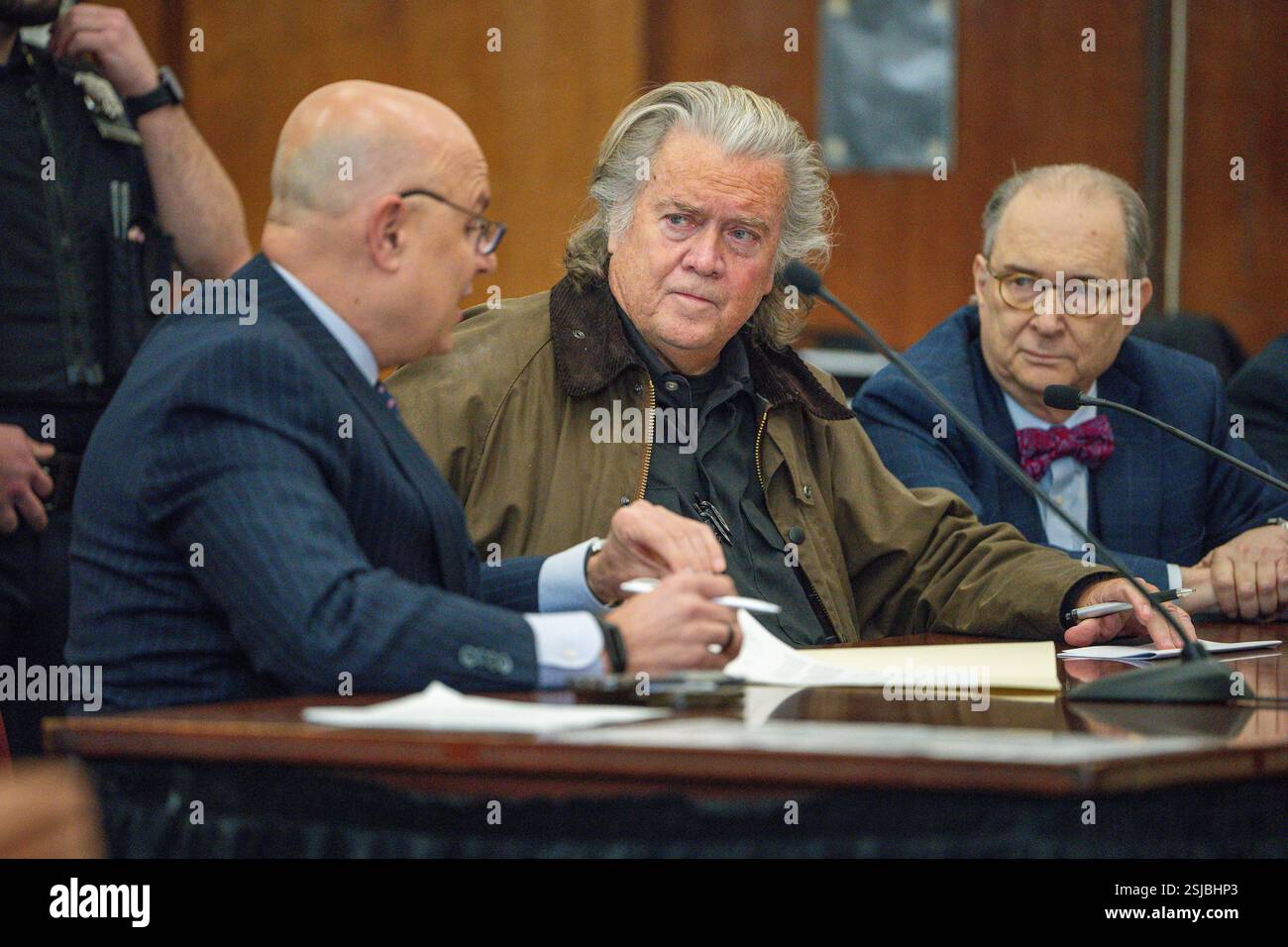 Steve Bannon listens to one of his lawyers in court, Tuesday, Feb. 11 ...