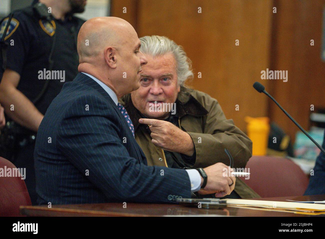 Steve Bannon speaks with his lawyer in court, Tuesday, Feb. 11, 2025 in ...