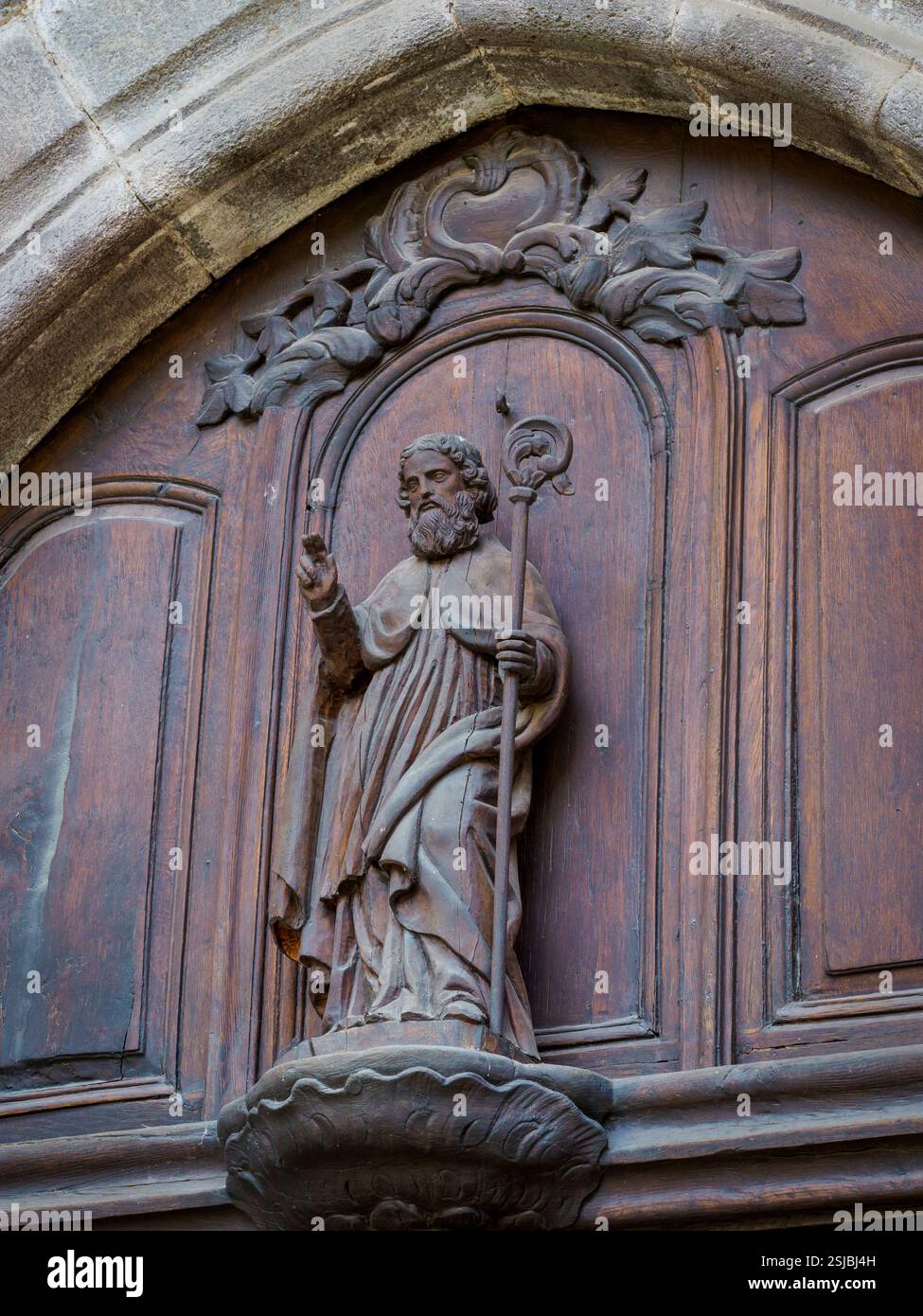 Wooden statue at the top of the wooden door of the porch of the Church ...
