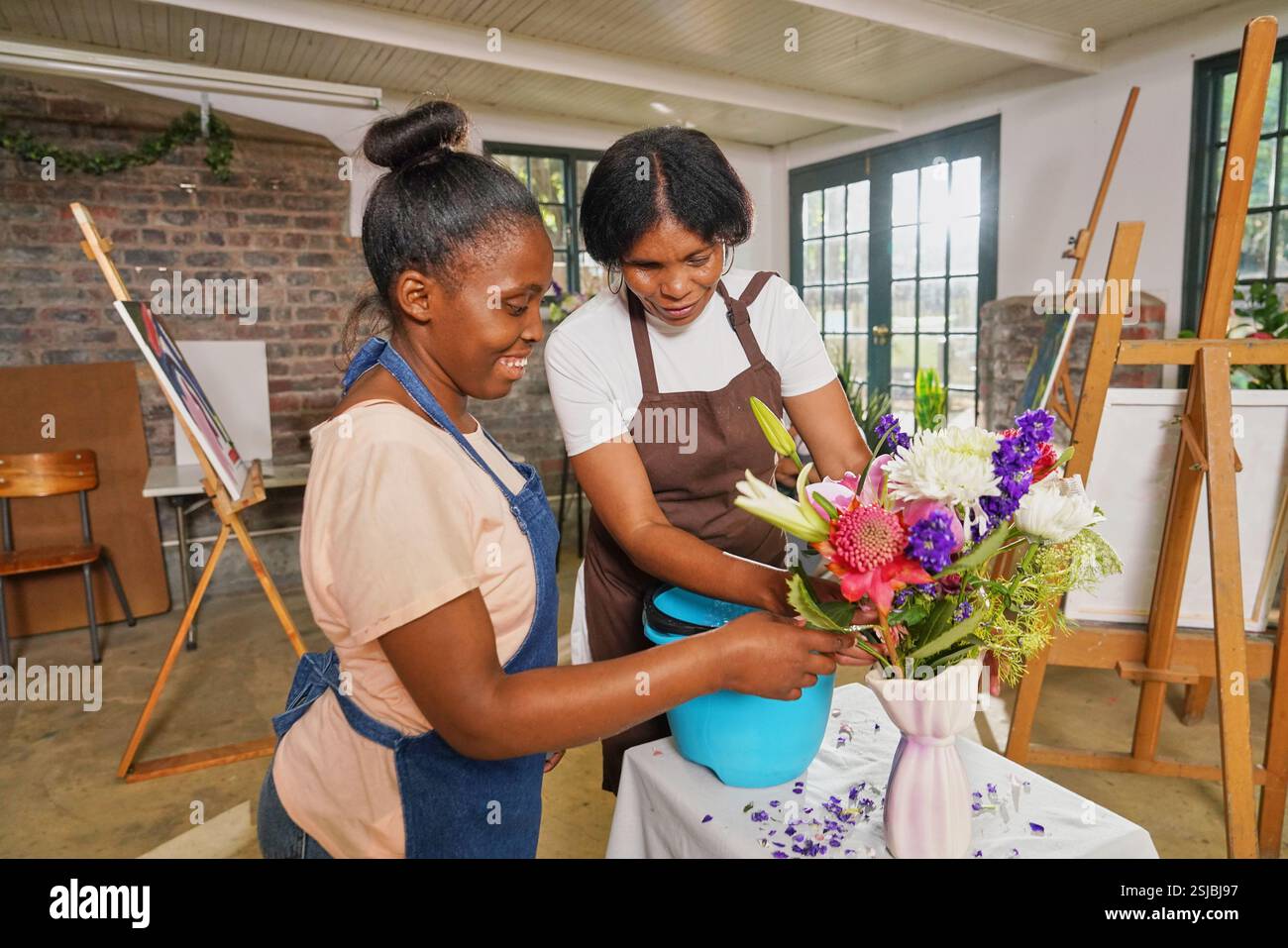 Disabled women arranging flowers during art class Stock Photo - Alamy