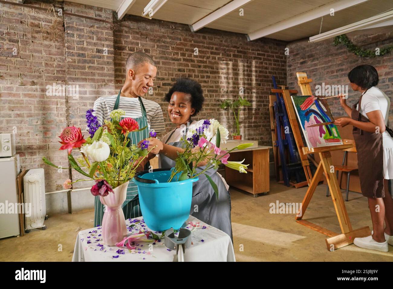 Disabled friends arranging flowers in workshop Stock Photo - Alamy