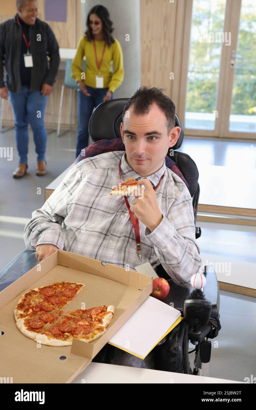 Disabled man enjoying pizza Stock Photo - Alamy