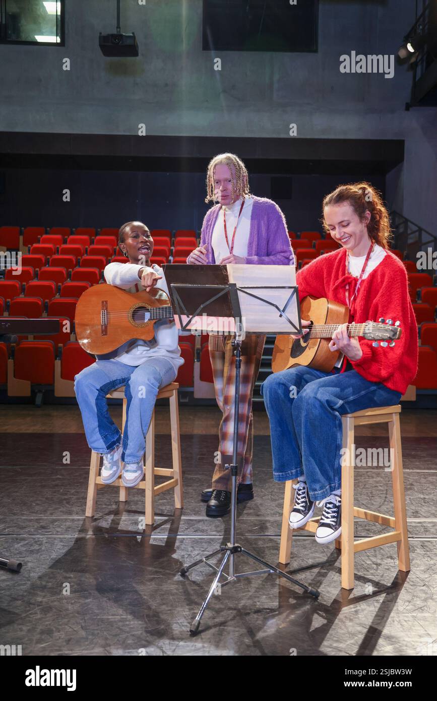 Friends playing guitars during rehearsal Stock Photo - Alamy