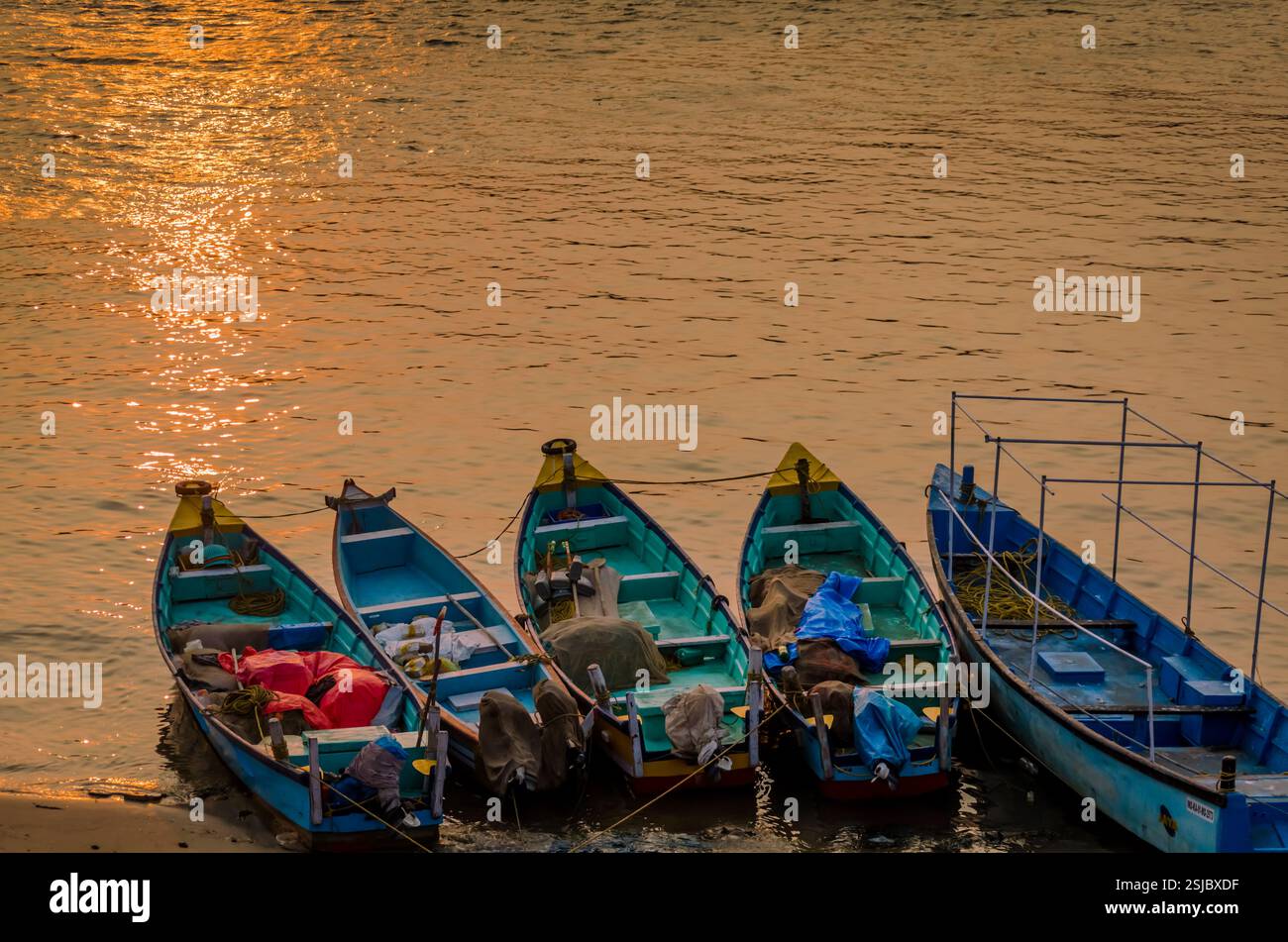 Aerial shot of Wooden Boats tied on the shore during sunset in Malpe ...