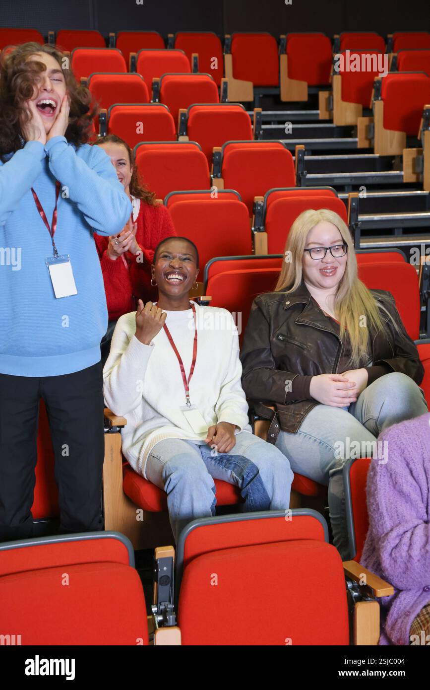 Disabled people sitting on seats in theatre Stock Photo - Alamy