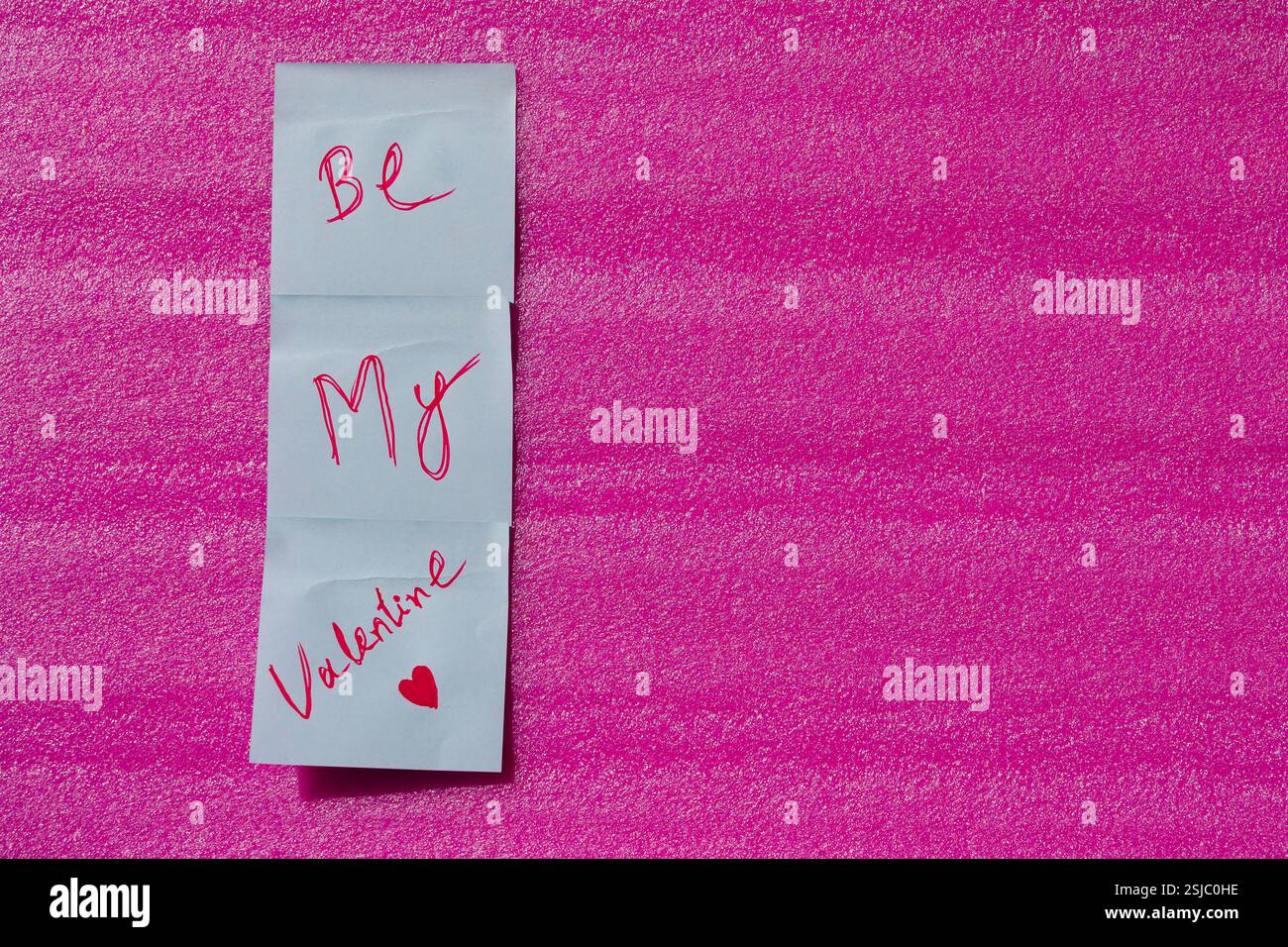 A charming sticky note with a heartfelt Valentine’s message on a pastel ...