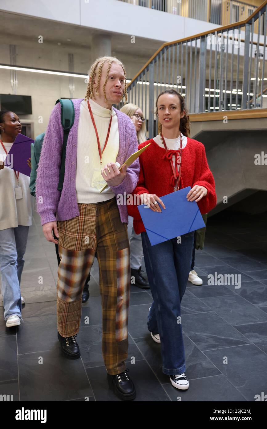 Disabled friends walking in community center Stock Photo - Alamy