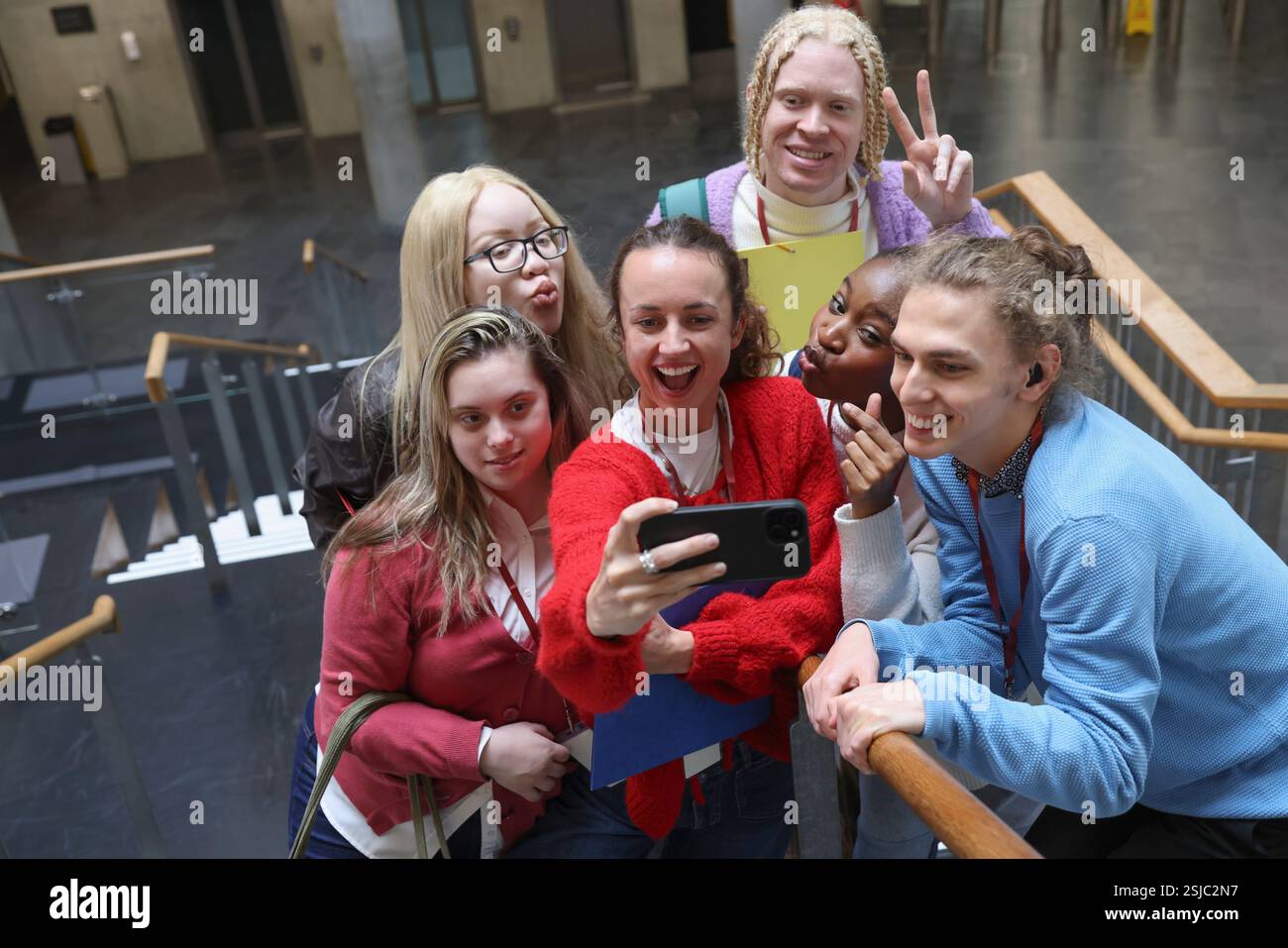 Disabled friends taking selfie in community center Stock Photo - Alamy