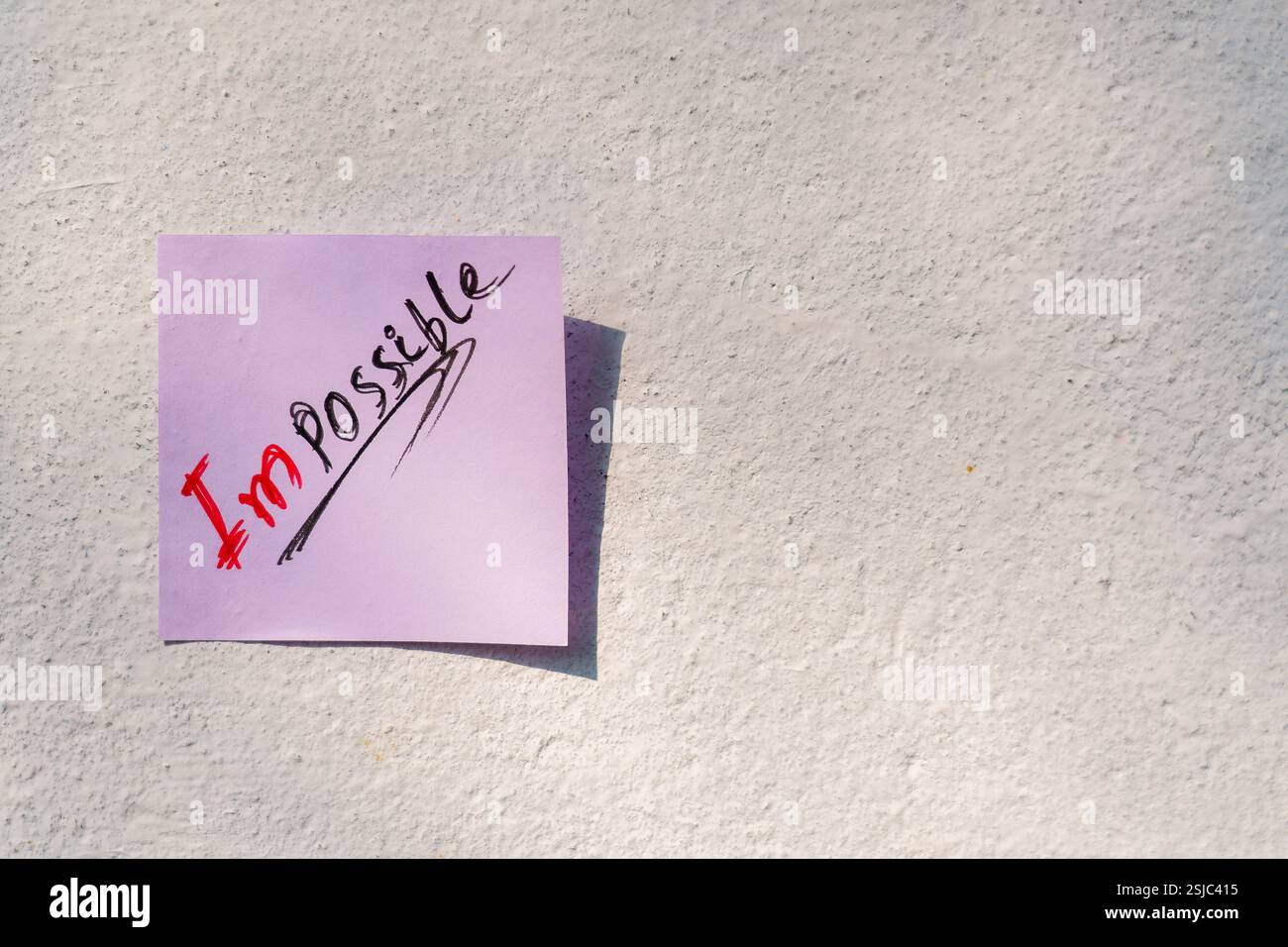 A sticky note with "Impossible" altered to "I'm Possible," symbolizing ...