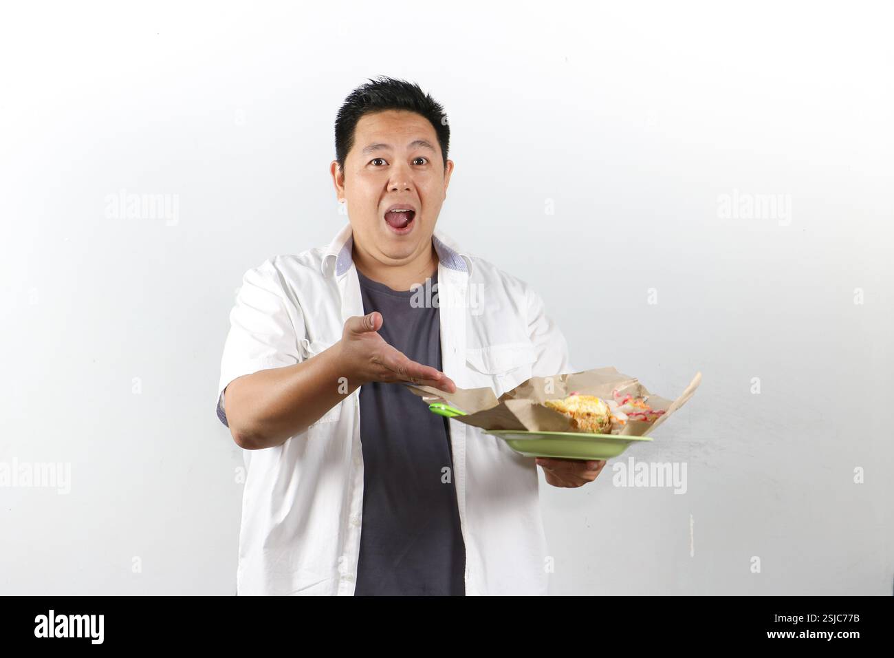 Shocked expression Man serving a plate of Indonesian Fried Rice Stock ...