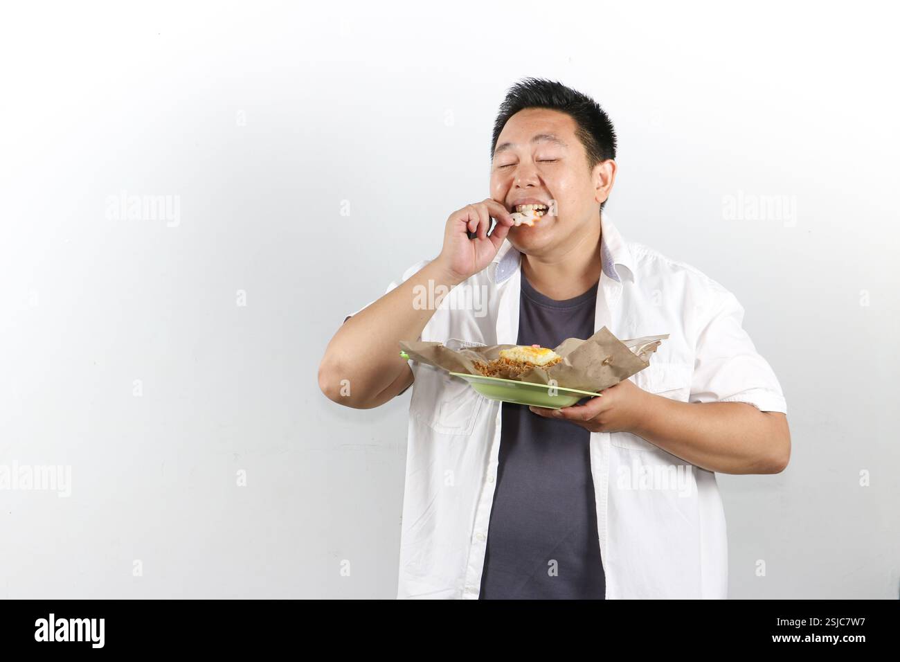 Shocked expression Man serving a plate of Indonesian Fried Rice Stock ...