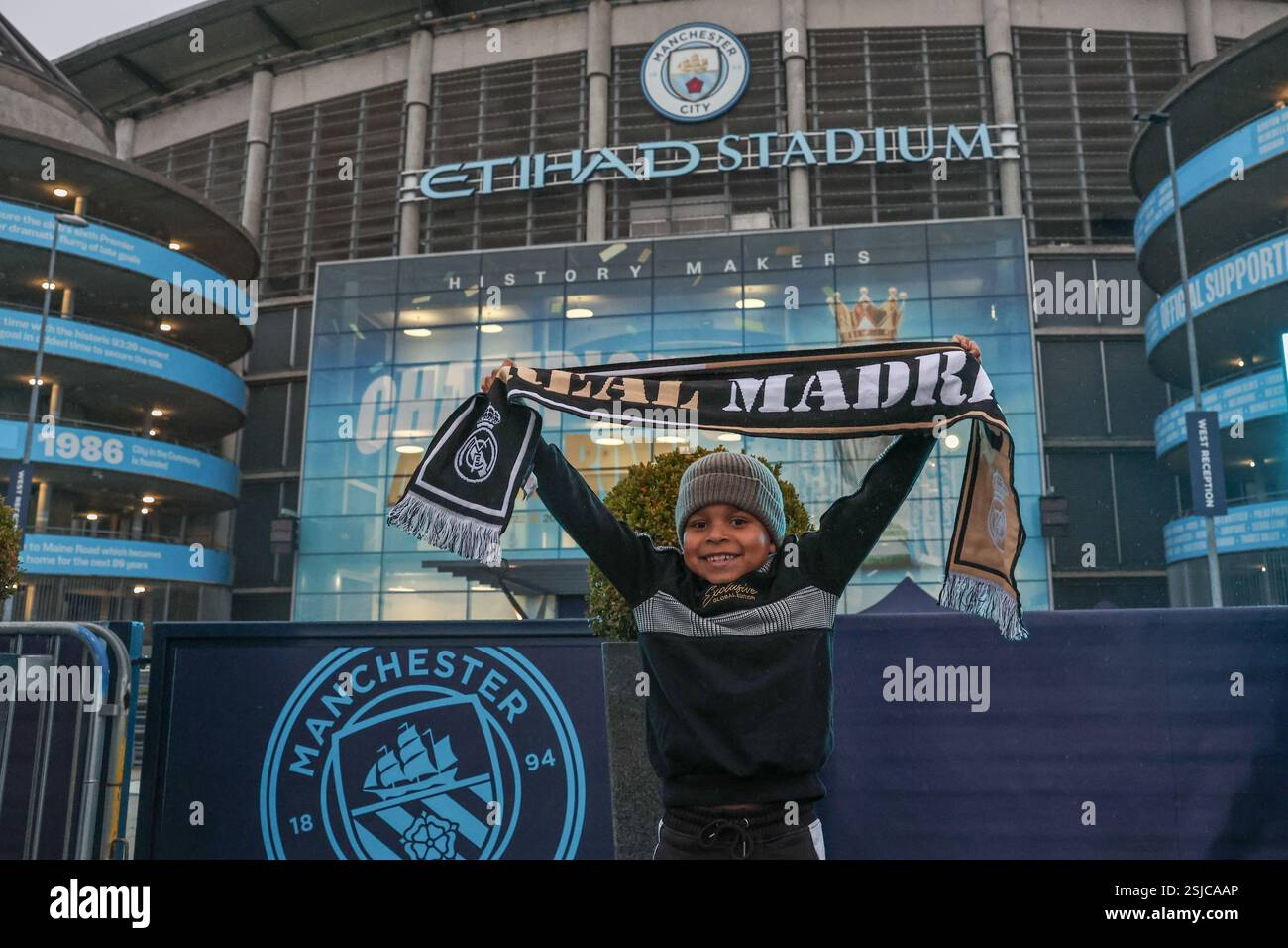 A young Real Madrid fan holds up his scarf during the UEFA Champions ...