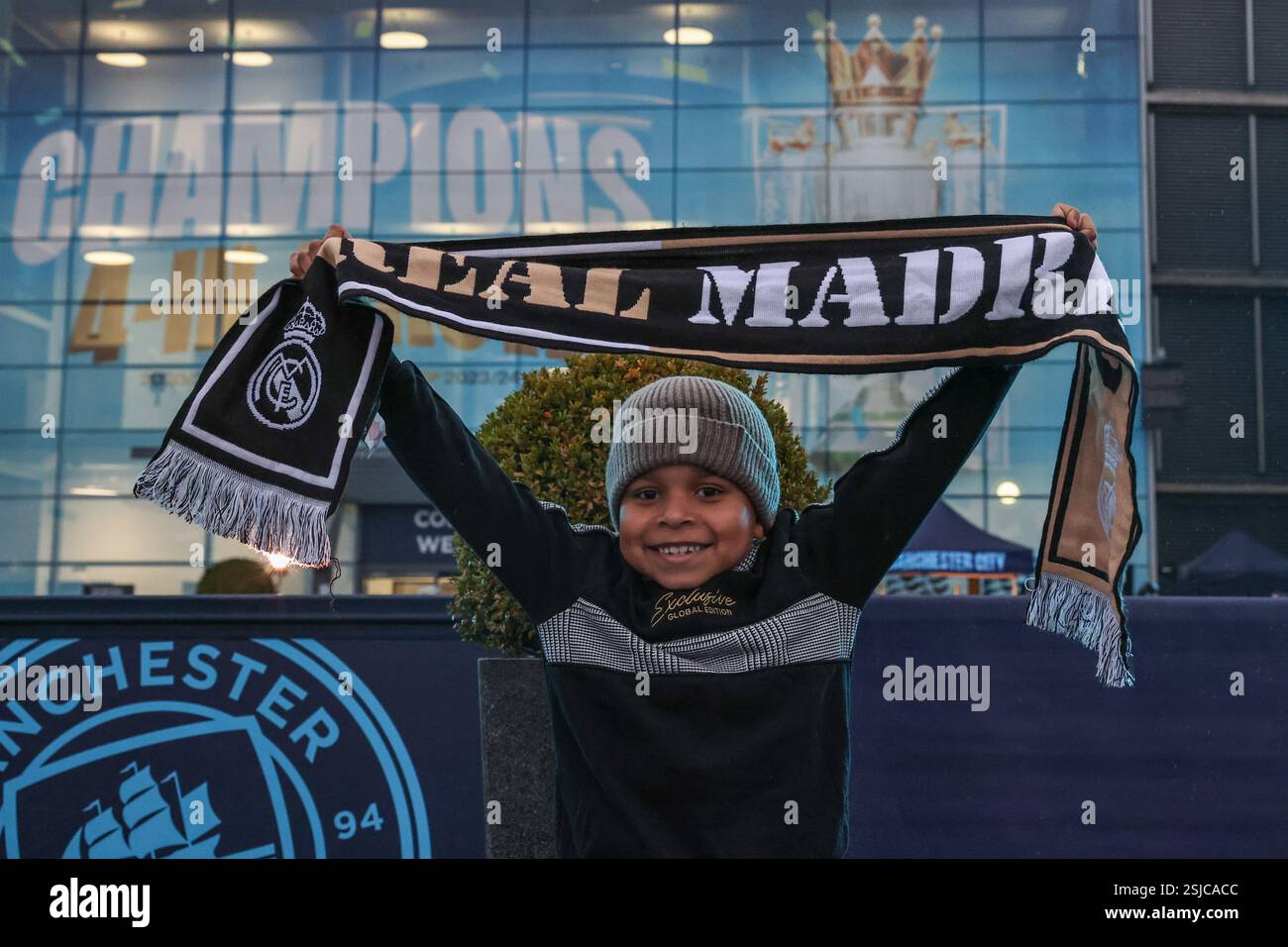 A young Real Madrid fan holds up his scarf during the UEFA Champions ...