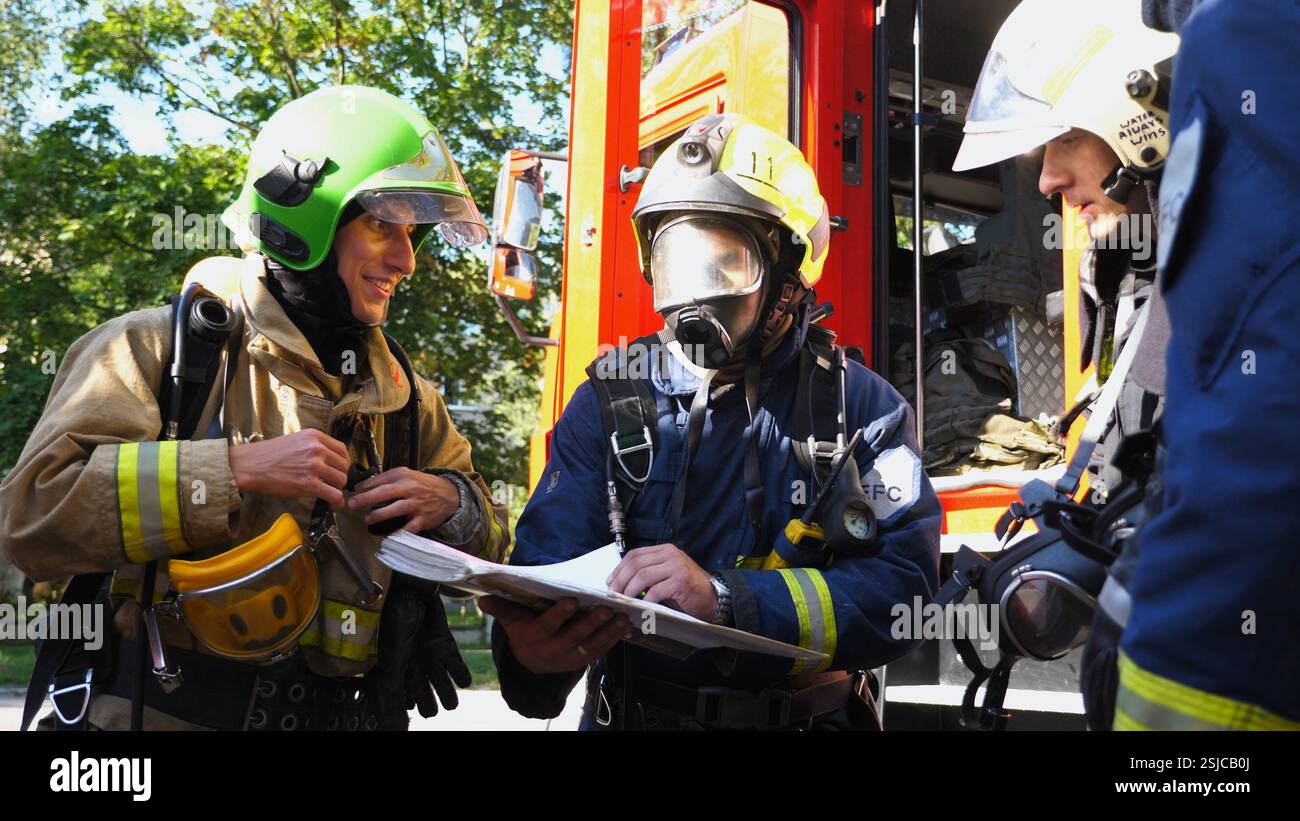 Male firefighters in protective uniforms hi-res stock photography and ...