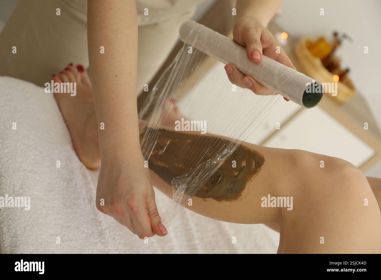 Woman undergoing body wraps treatment in spa salon, closeup Stock Photo ...