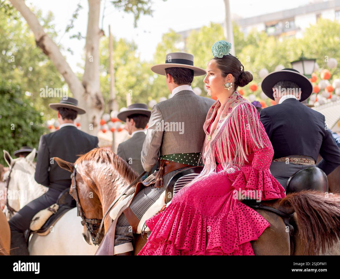 Group of Spanish riders in traditional attire on horseback at an ...