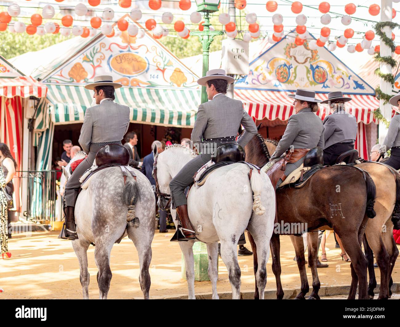 Group of Spanish riders in traditional attire on horseback at an ...