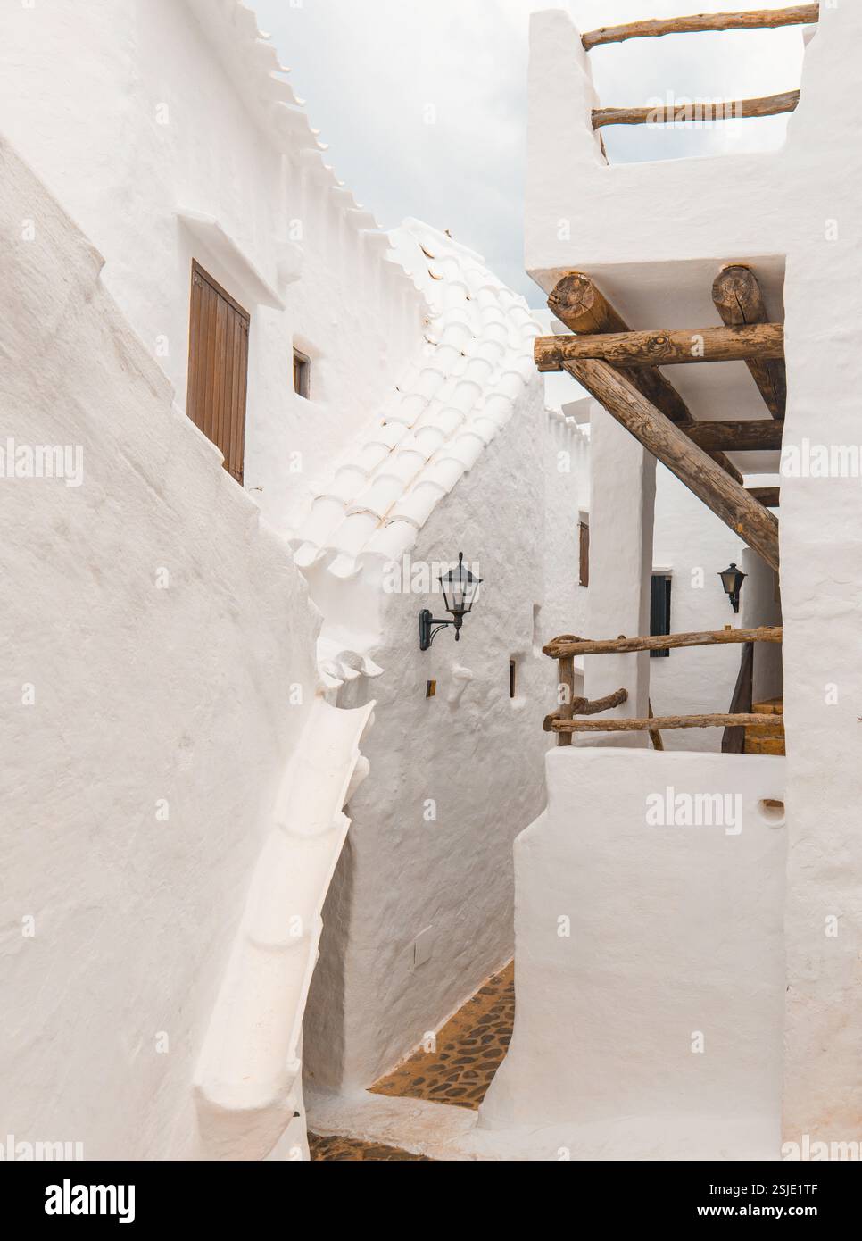 The charming town of Binibeca on Menorca. Narrow streets and white ...