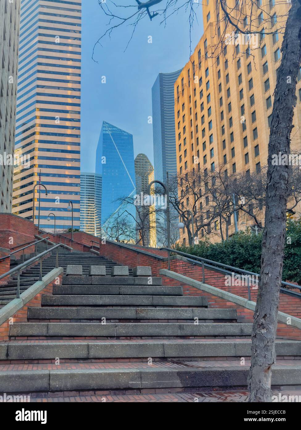A set of concrete stairs leads upwards towards a cityscape of Seattle ...