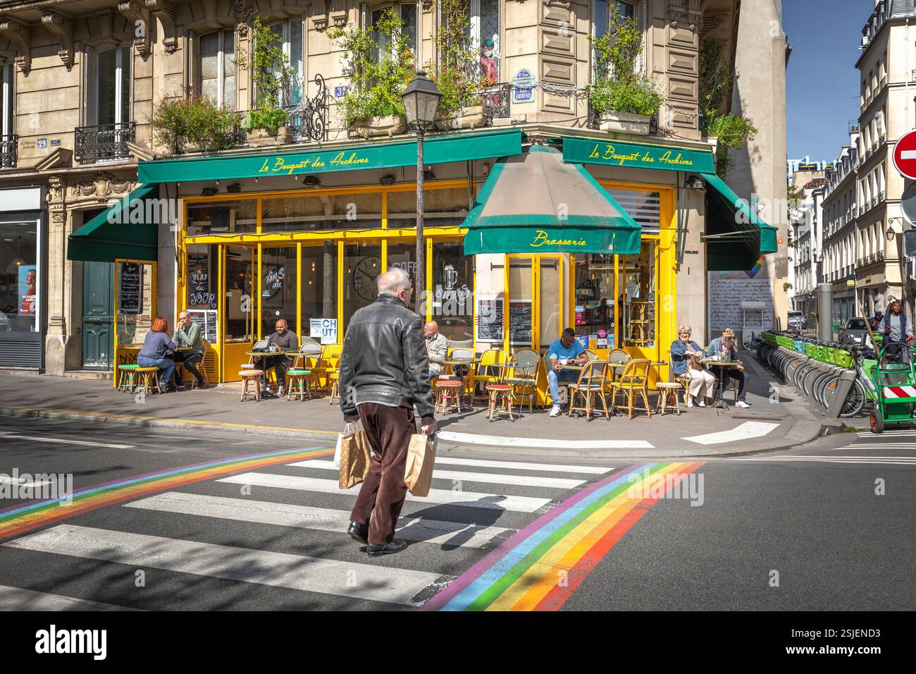 Pedestrian walking across a rainbow zebra crossing in Paris Stock Photo - Alamy