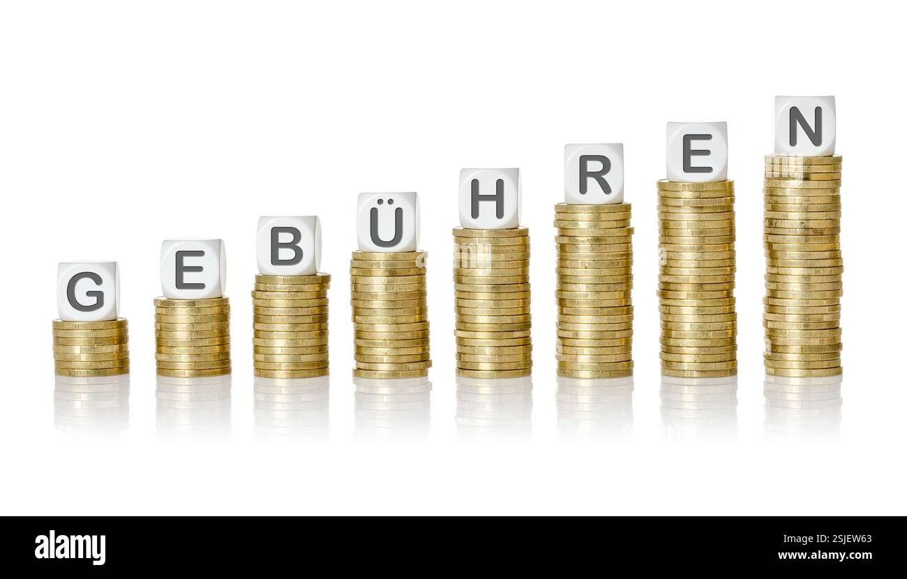 Stack of coins with letter cubes - fees Stock Photo - Alamy