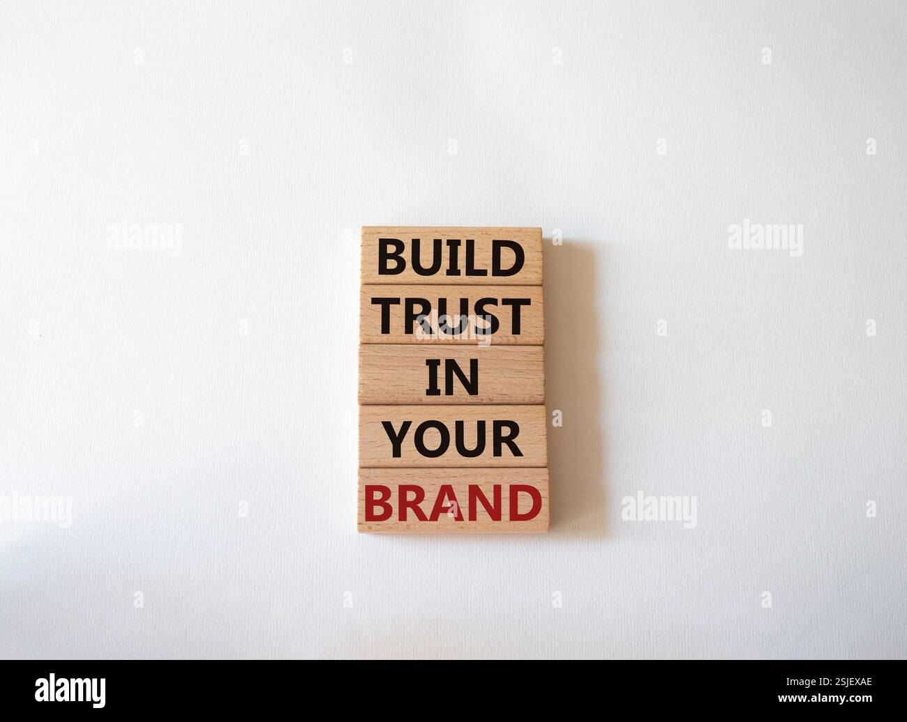 Build trust in your brand symbol. Wooden blocks with words Build trust ...