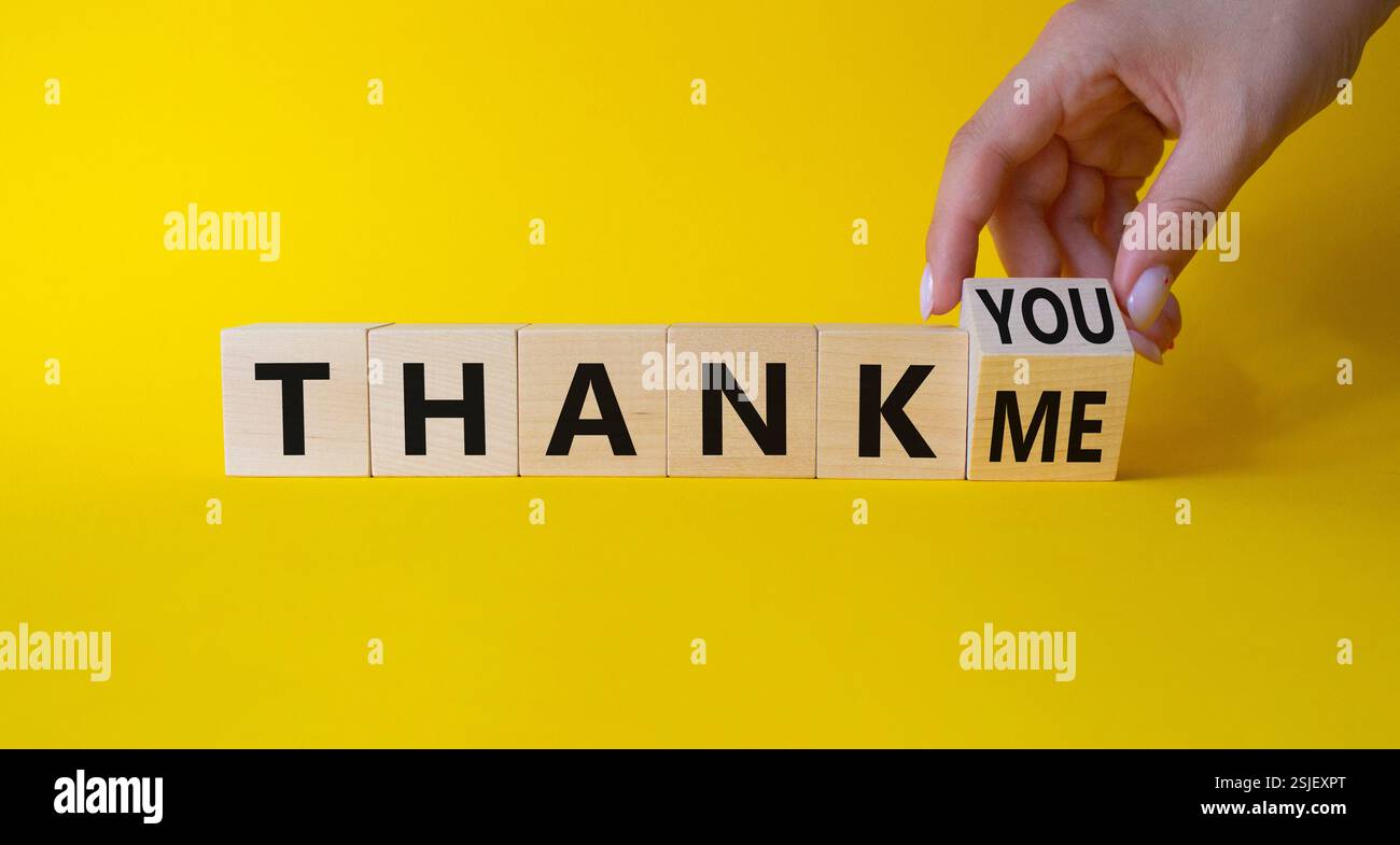 Thank You or Me symbol. Businessman Hand turns cubes and changes words ...