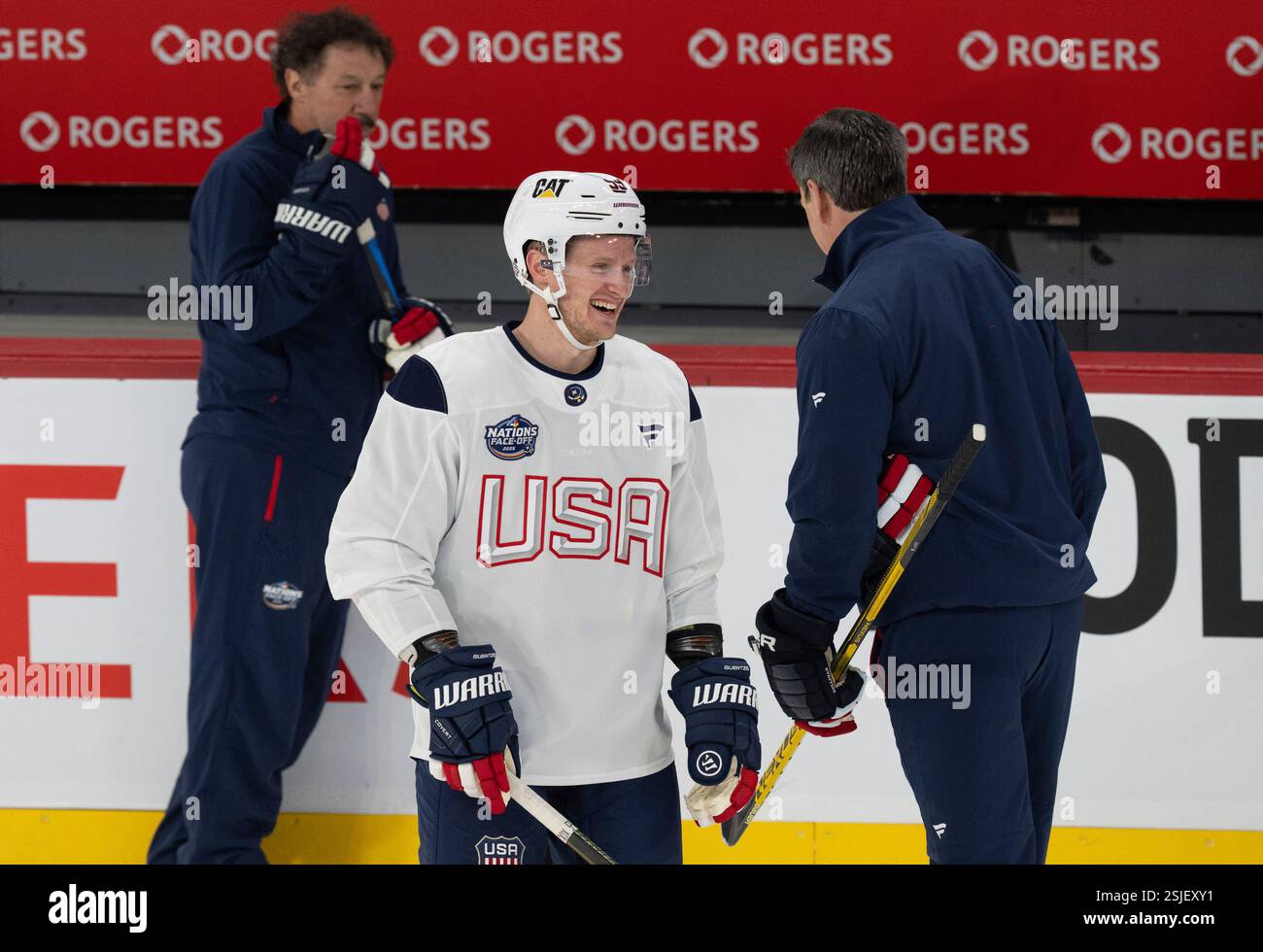 U.S.A. Jake Guentzel (59) laughs after speaking with head coach Mike ...