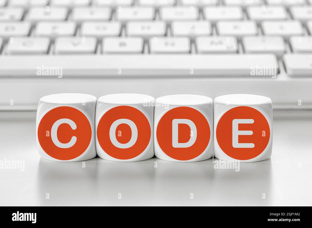 Letter cube in front of a keyboard - Code Stock Photo - Alamy