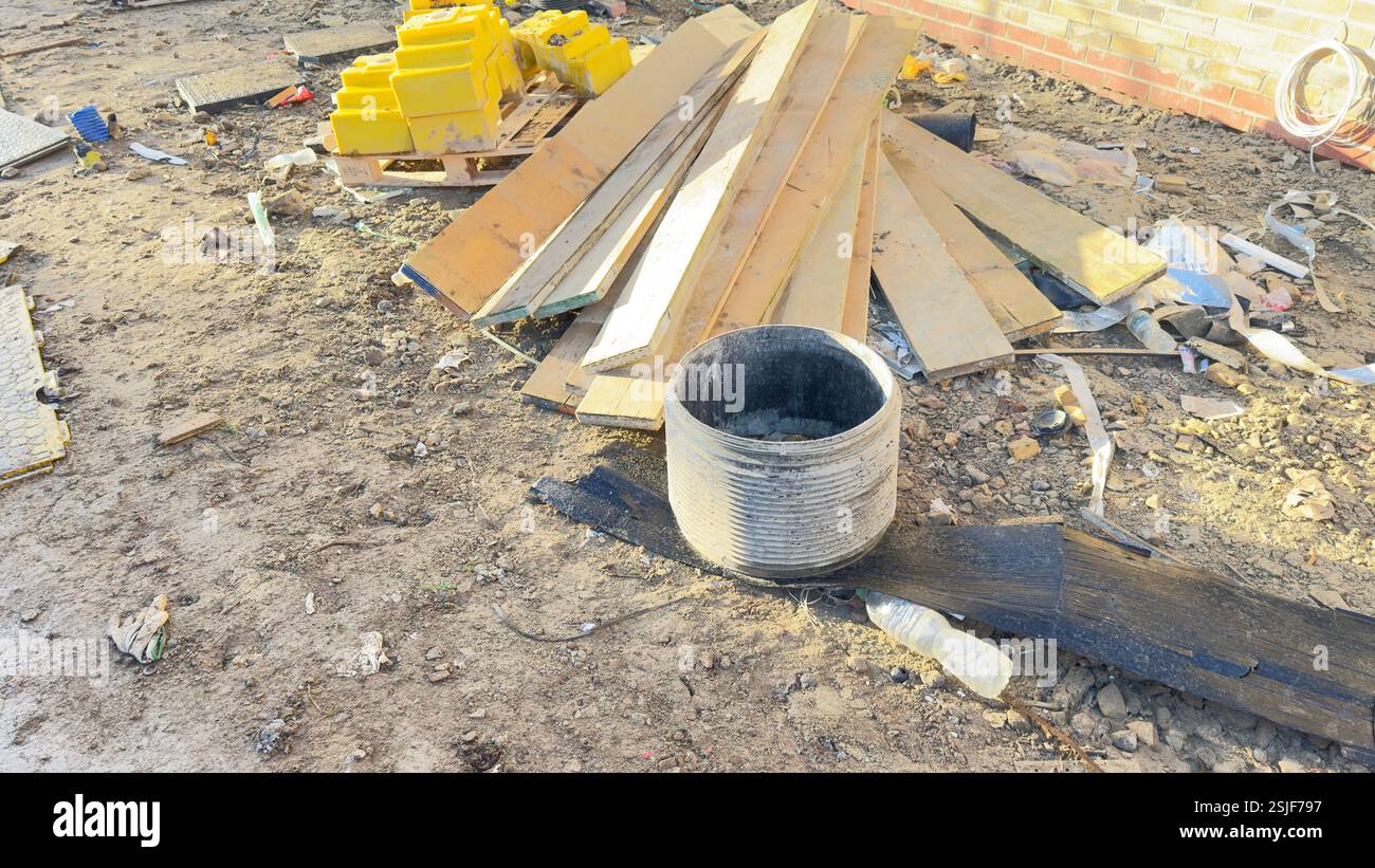 Construction debris scattered on a dirt ground. Wooden planks, a ...