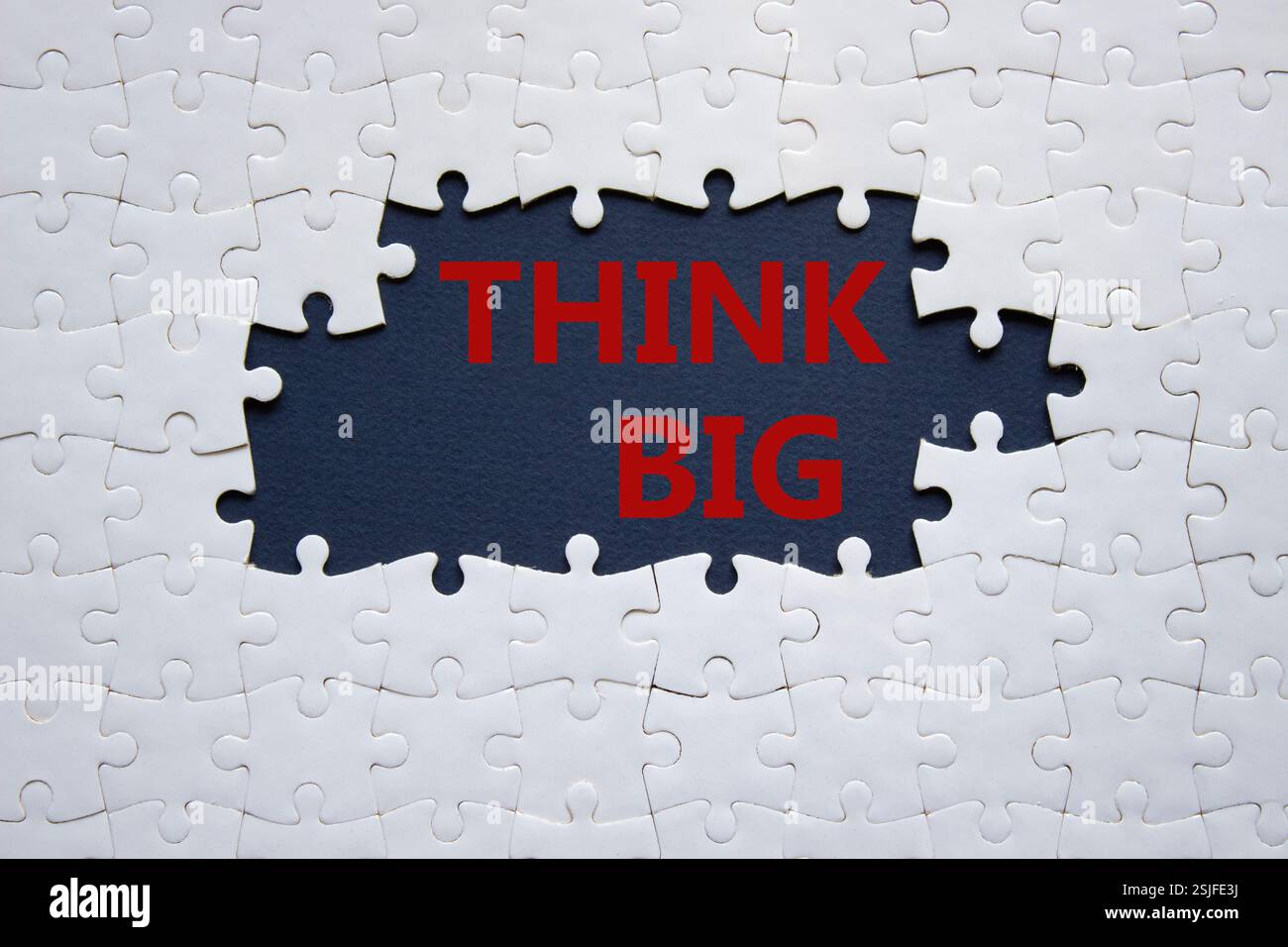 Think big symbol. White puzzle with words Think big. Beautiful dark ...