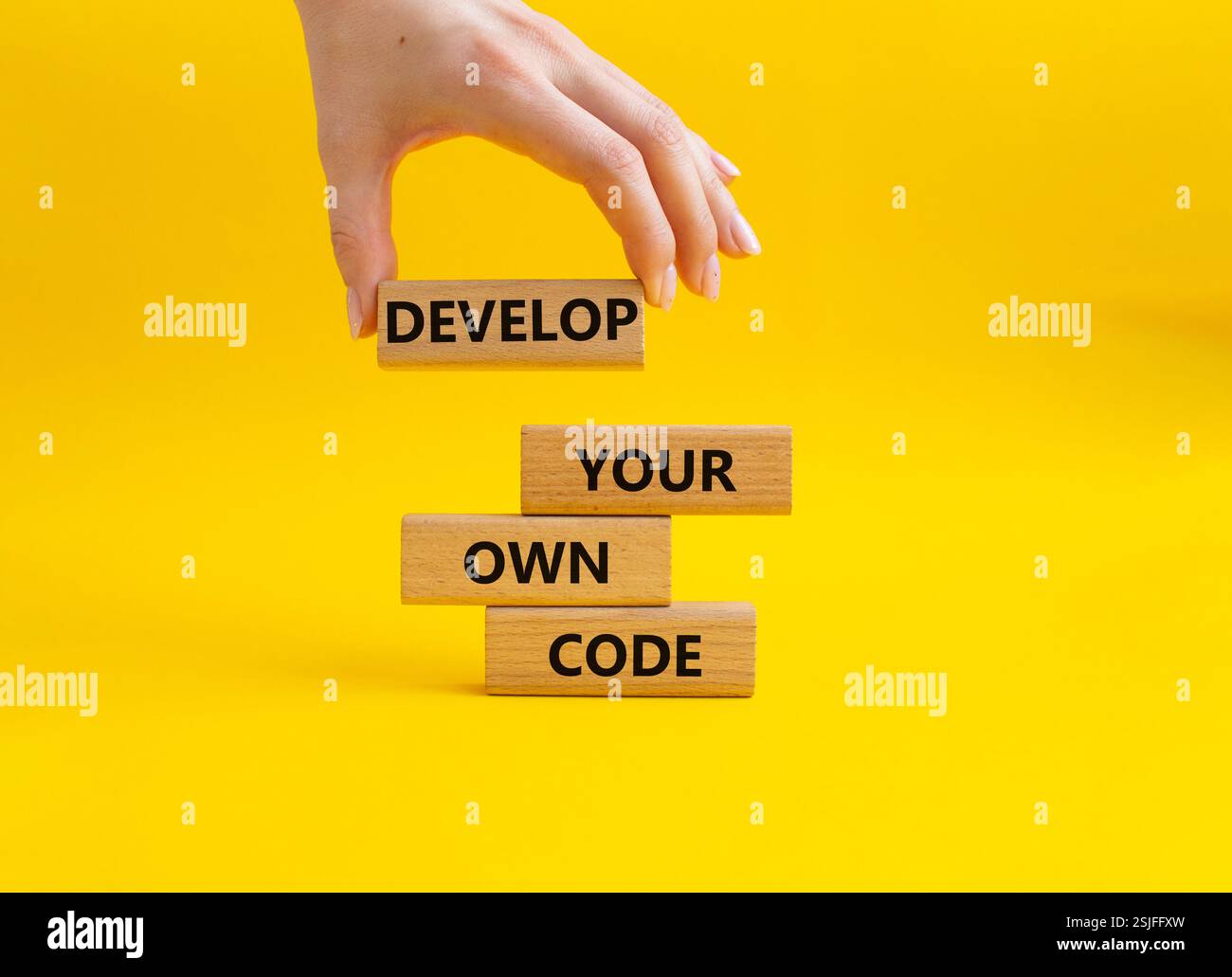 Develop Your Own Code Symbol Concept Words Develop Your Own Code On Wooden Blocks Businessman
