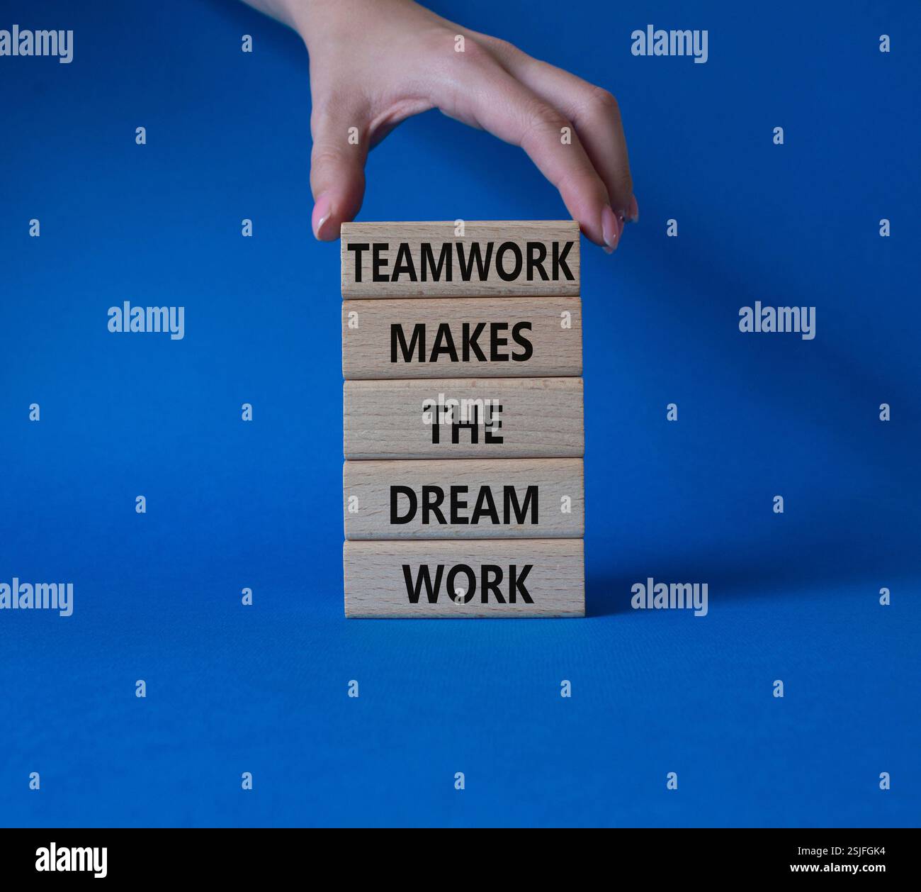 Teamwork symbol. Wooden blocks with words Teamwork makes the Dream work ...