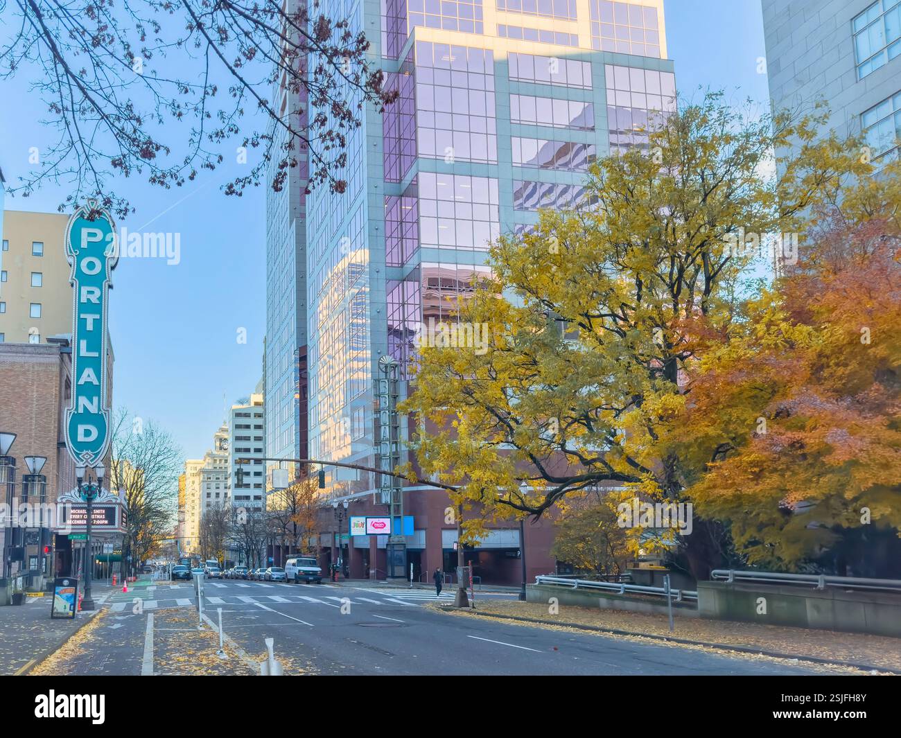 A street scene in Portland, Oregon, with a prominent green sign reading ...