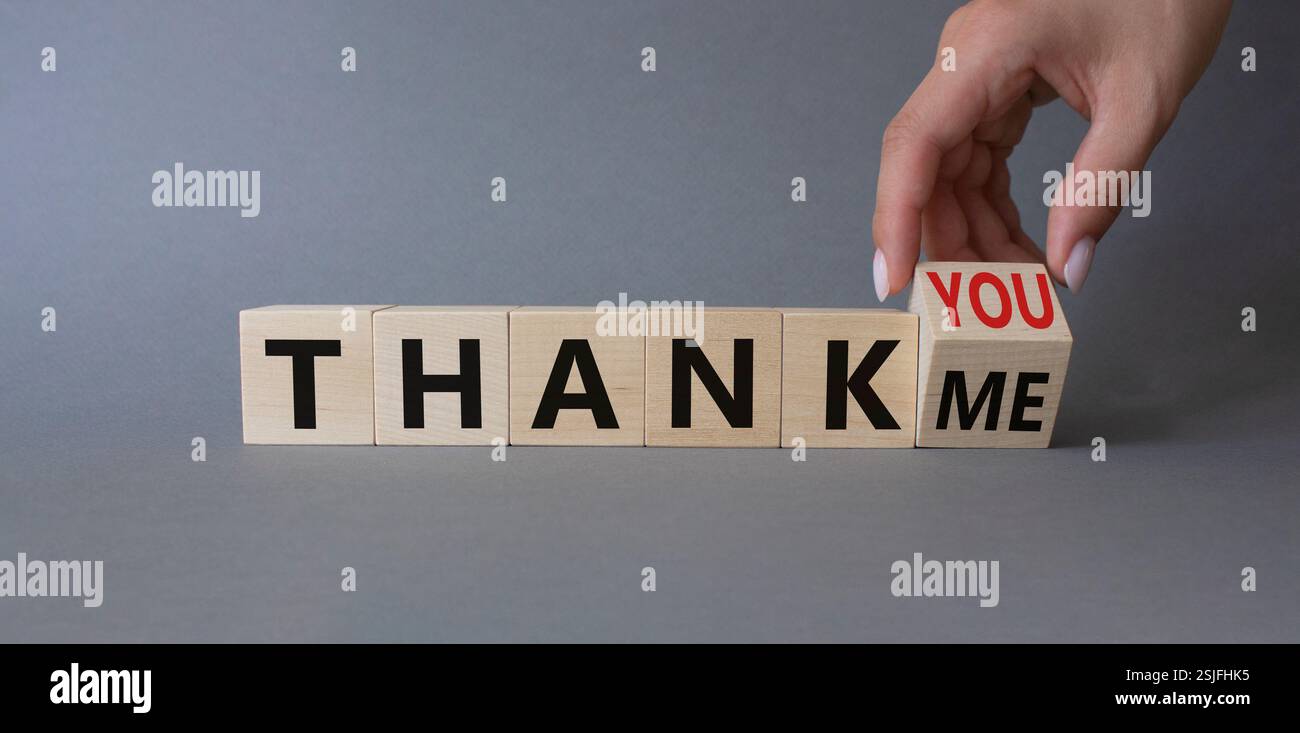 Thank You or Me symbol. Businessman Hand turns cubes and changes words ...