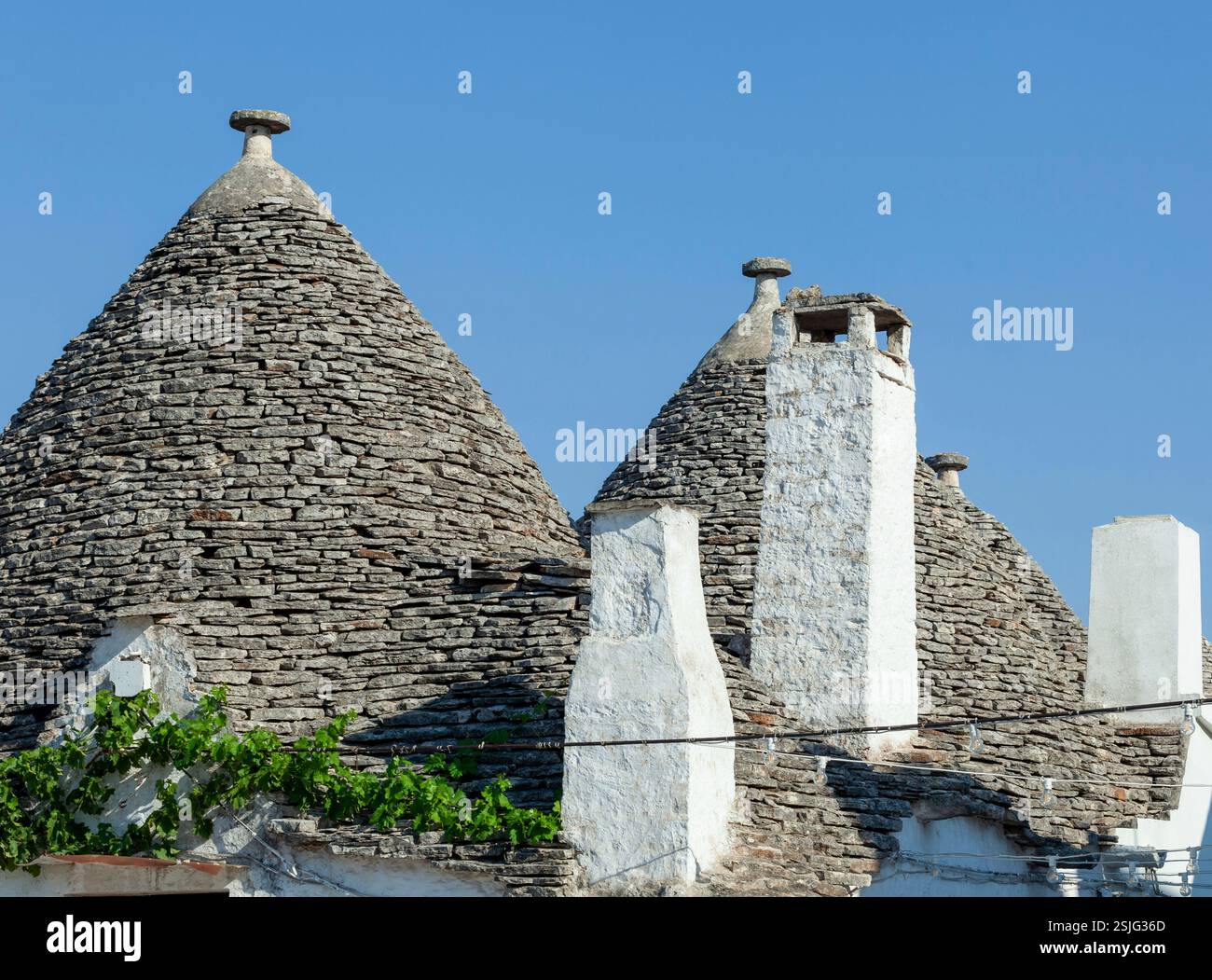 Traditional trulli houses with conical roofs made of stone in ...