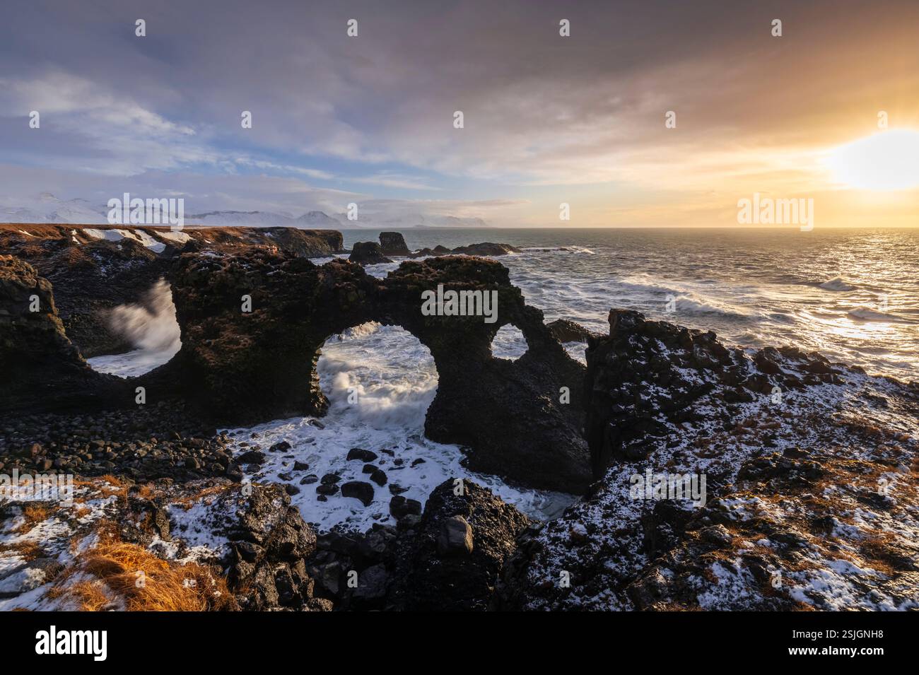 View of the Gatklettur rock arch at sunrise in winter. Arnarstapi ...