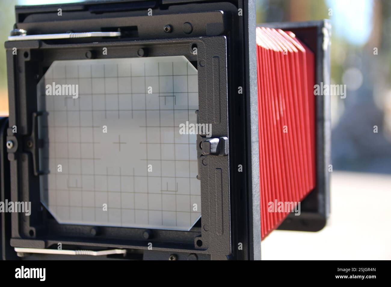 Looking at the ground glass at the rear of a large format 4x5 monorail bellows camera for ...